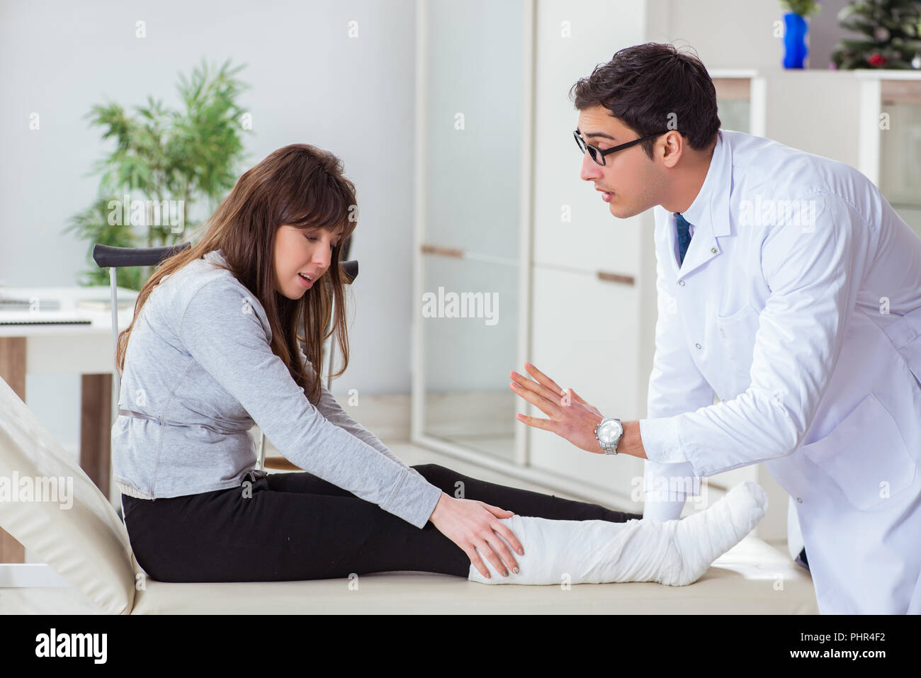 Doctor examining patient with broken leg Stock Photo - Alamy