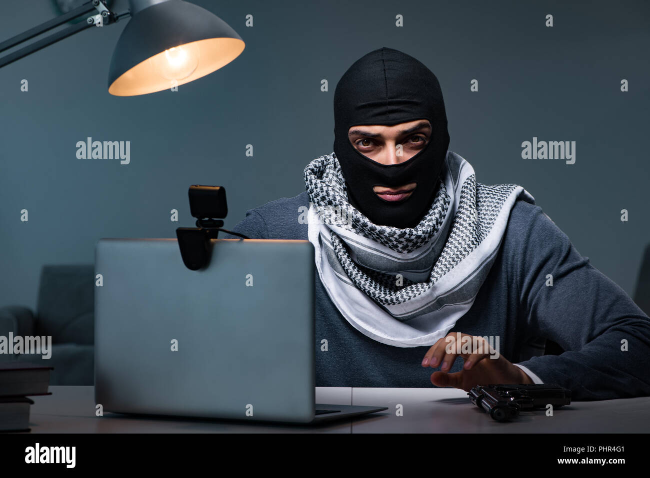Hacker wearing balaclava mask hacking computer Stock Photo - Alamy