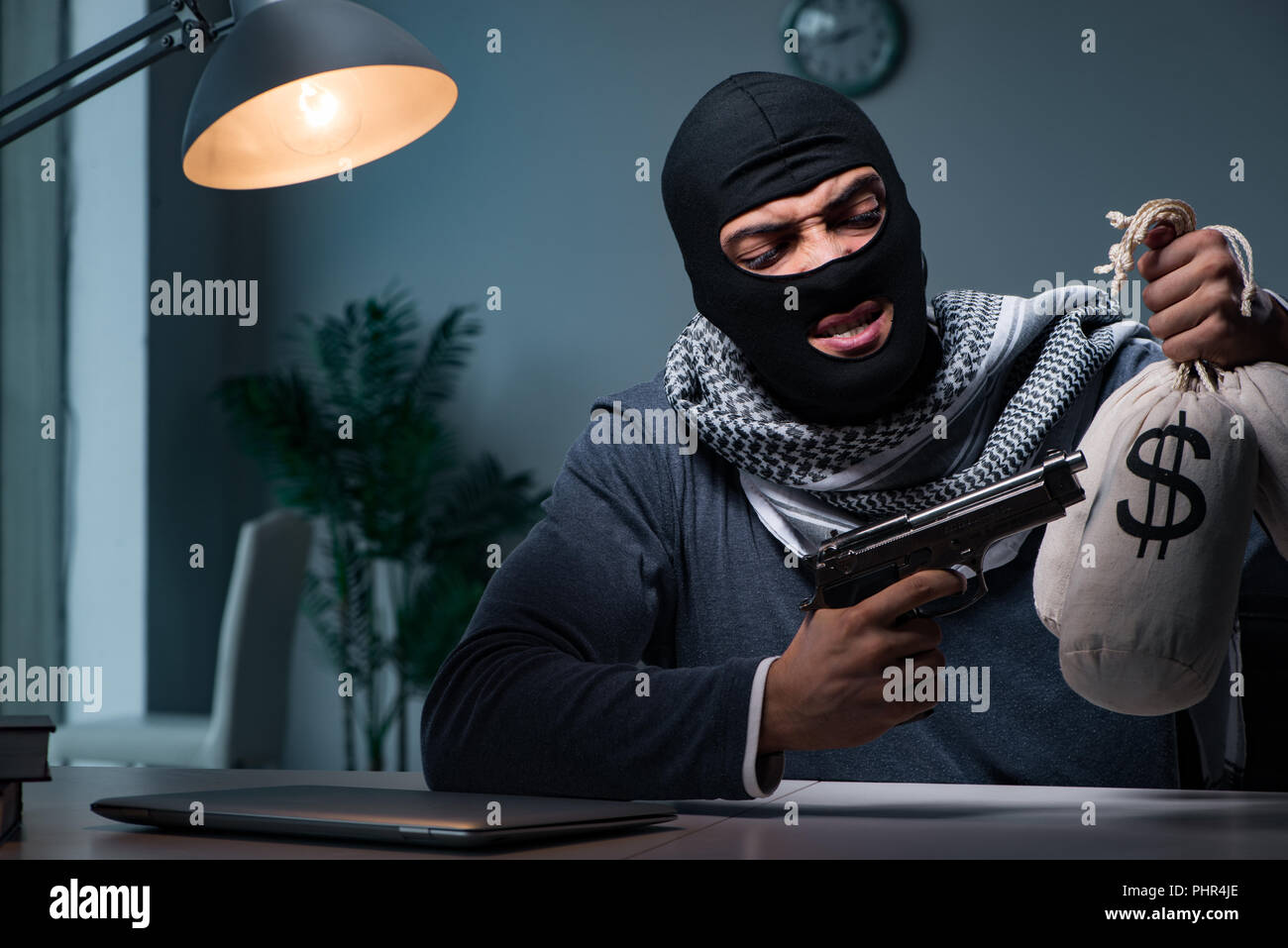 Terrorist burglar with gun asking for money ransom Stock Photo - Alamy