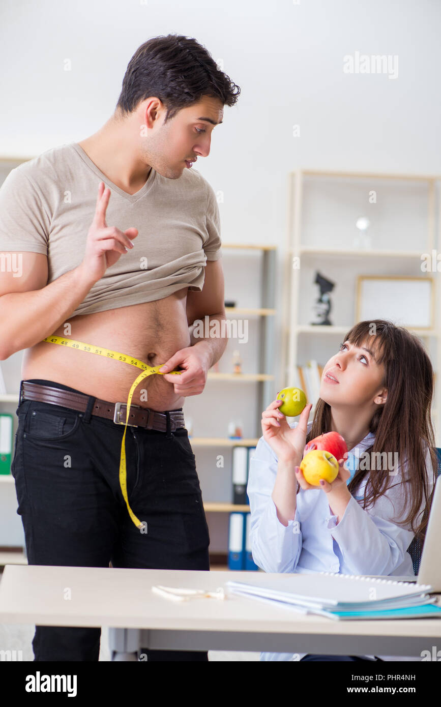 Doctor dietician giving advices to fat overweight patient Stock Photo ...