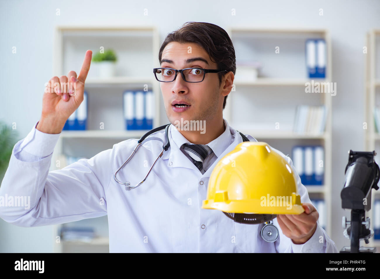 Safety doctor advising about wearing hard hat Stock Photo - Alamy