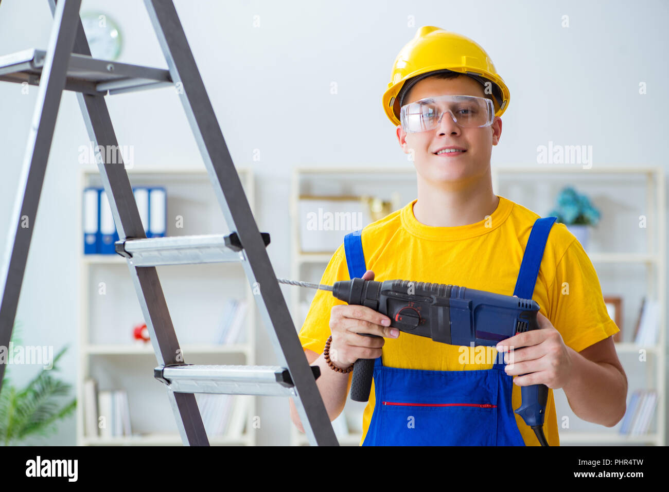 Young repairman with power drill Stock Photo - Alamy
