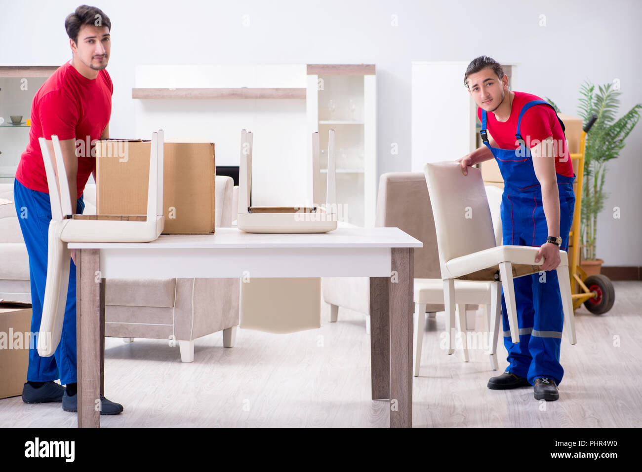 Two contractor employees moving personal belongings Stock Photo - Alamy