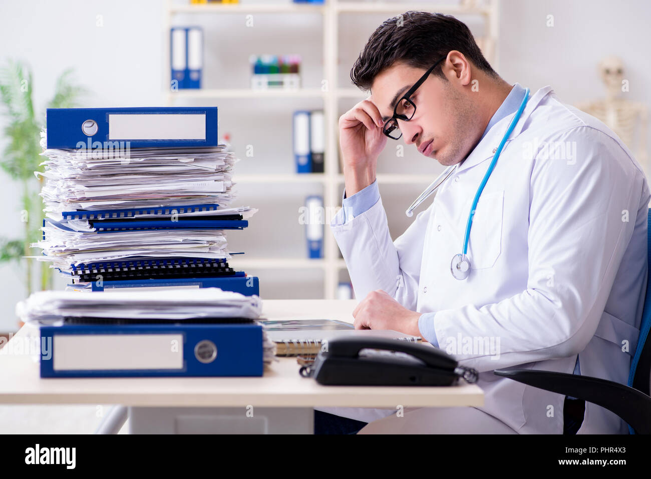 Busy doctor with too much work in hospital Stock Photo - Alamy
