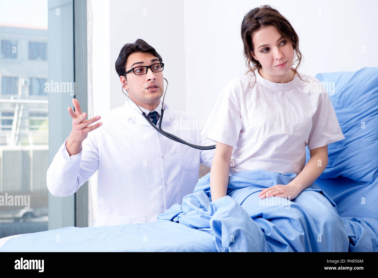 Doctor visiting patient in hospital room Stock Photo - Alamy
