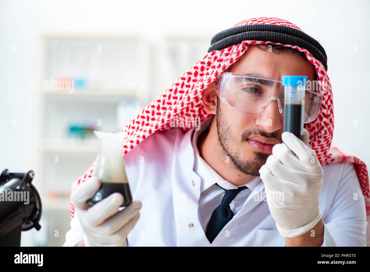 Arab chemist working in the lab office Stock Photo - Alamy