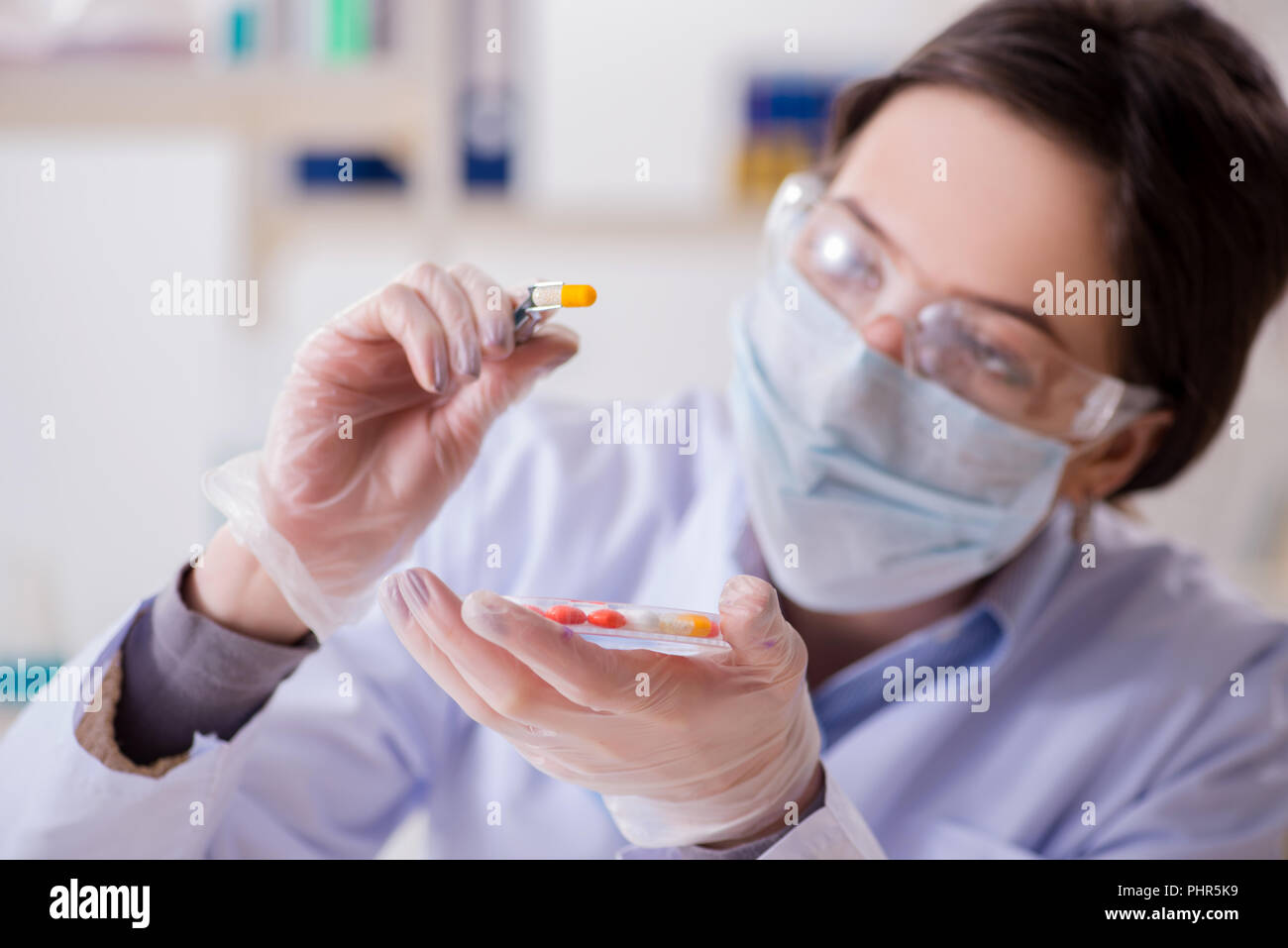 Lab assistant in drug synthesis concept Stock Photo - Alamy