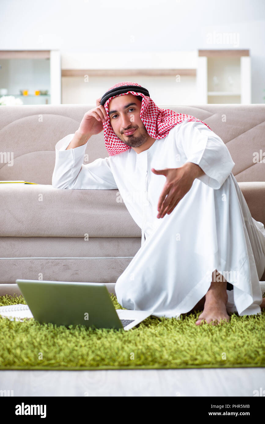 Arab man working at home on his work Stock Photo - Alamy