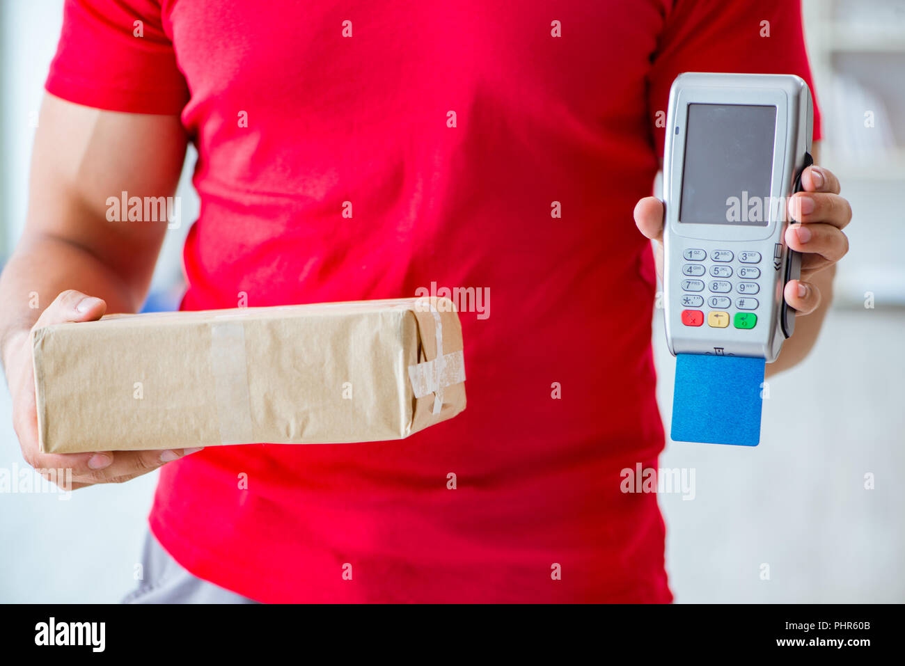 Parcel delivery being paid with pos and credit card Stock Photo - Alamy