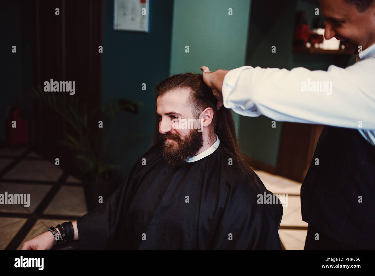 Barbershop with wooden interior. Bearded model man and barber Stock ...