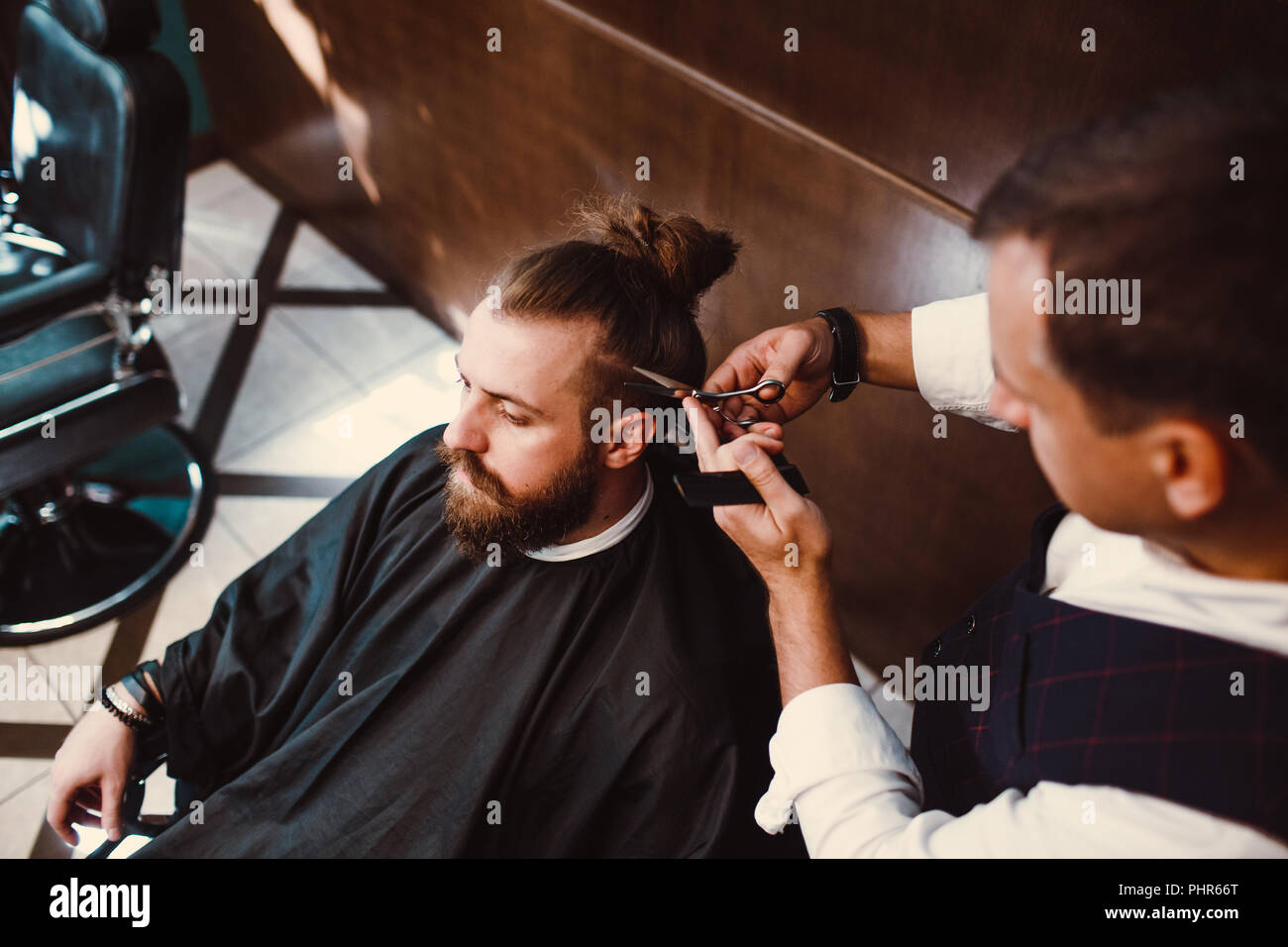 Barbershop with wooden interior. Bearded model man and barber Stock ...