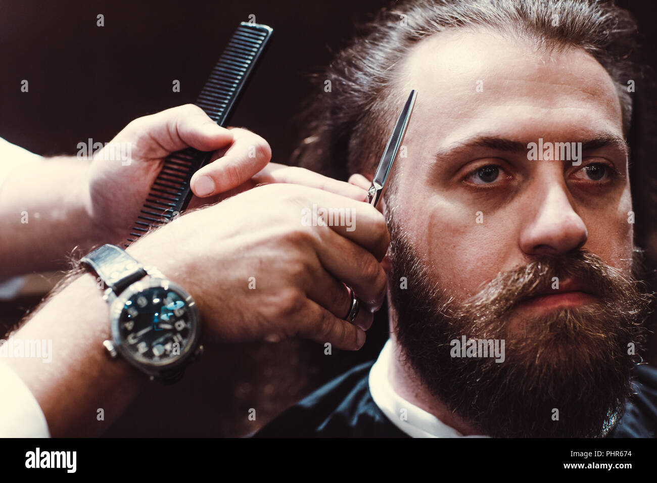 Barbershop with wooden interior. Bearded model man and barber Stock ...