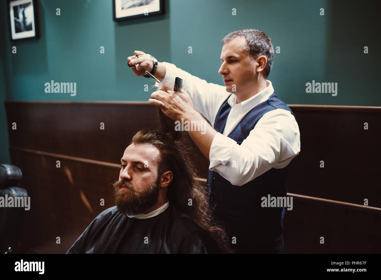 Barbershop with wooden interior. Bearded model man and barber Stock ...