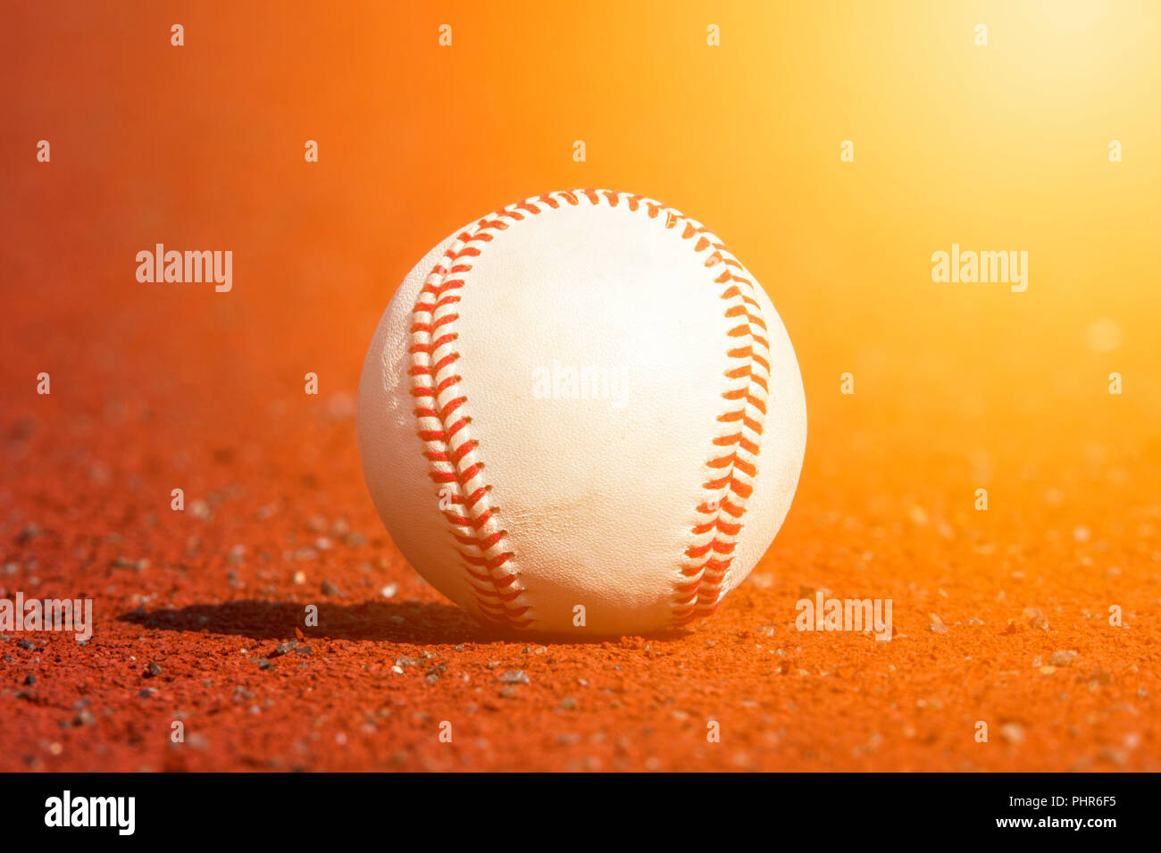 new baseball ball on red track rubber Stock Photo - Alamy