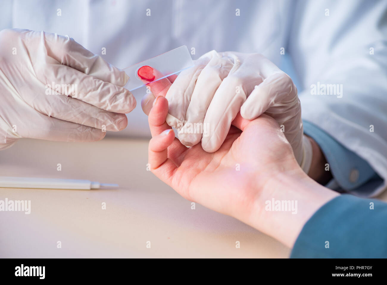 Doctor taking blood samples from finger Stock Photo - Alamy