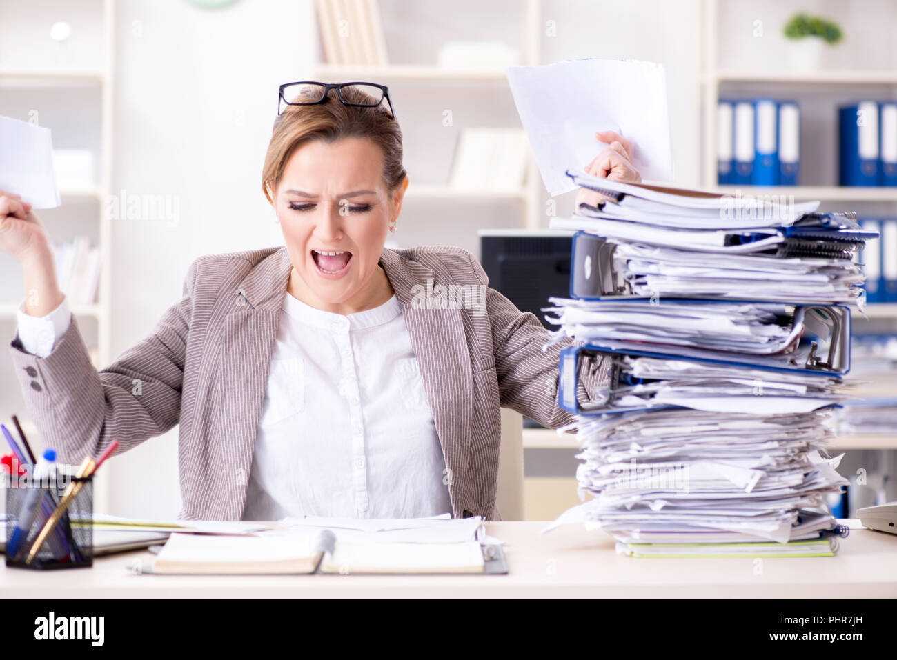 Businesswoman very busy with ongoing paperwork Stock Photo - Alamy