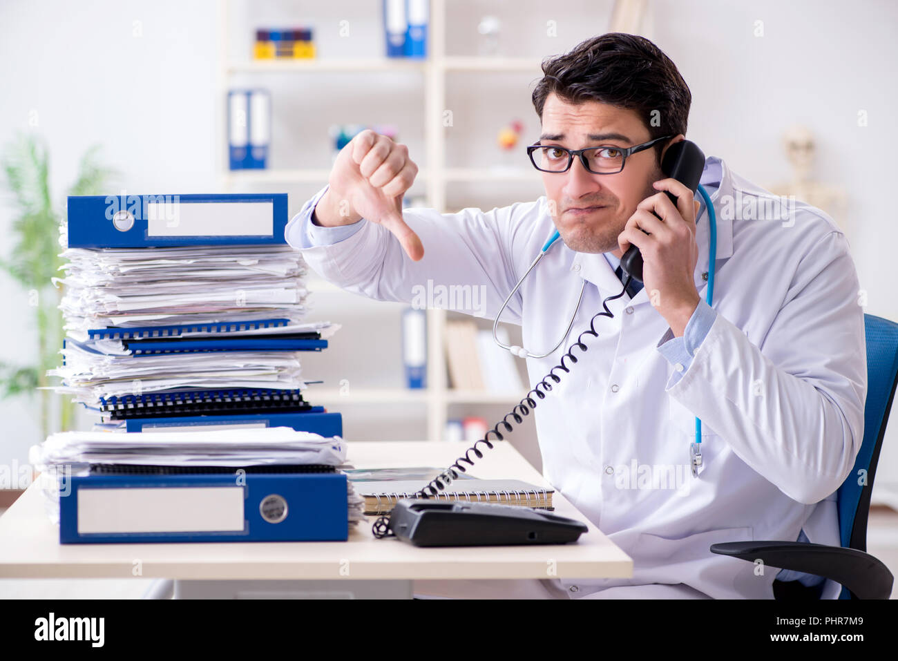 Busy doctor with too much work in hospital Stock Photo - Alamy
