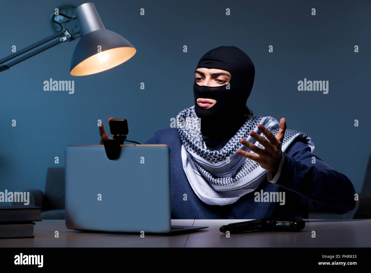 Hacker wearing balaclava mask hacking computer Stock Photo - Alamy