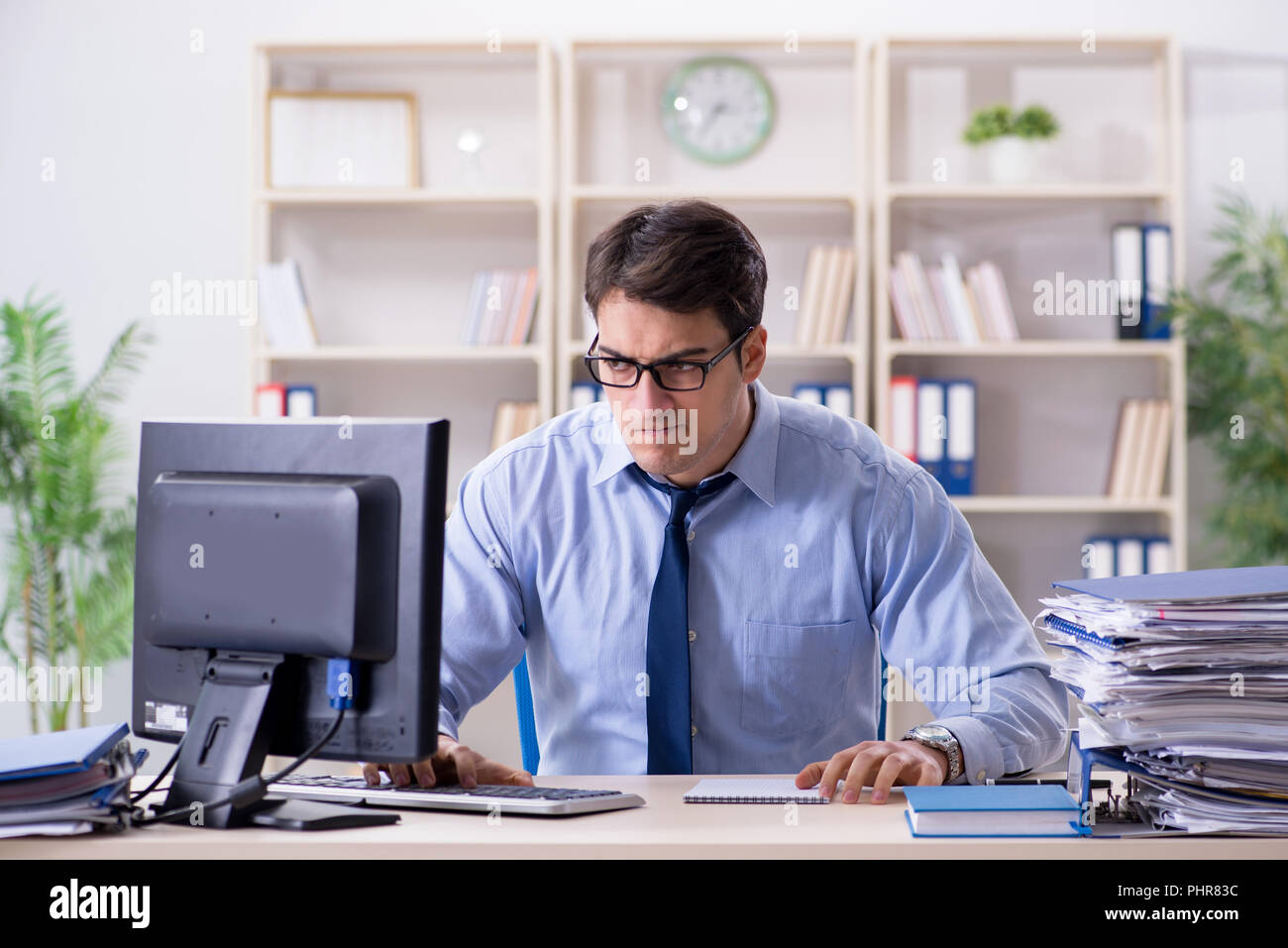 Tired businessman with too much paperwork Stock Photo - Alamy