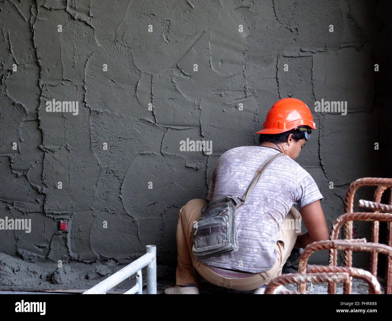 Construction workers plastering wall using cement plaster at the ...