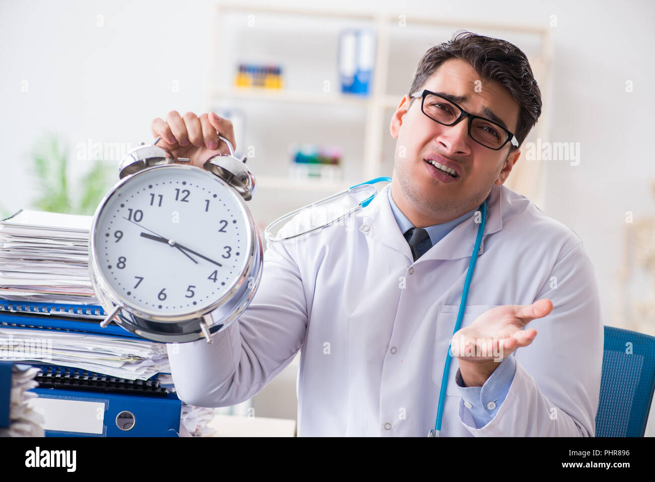 Doctor with alarm clock in urgent check-up concept Stock Photo - Alamy