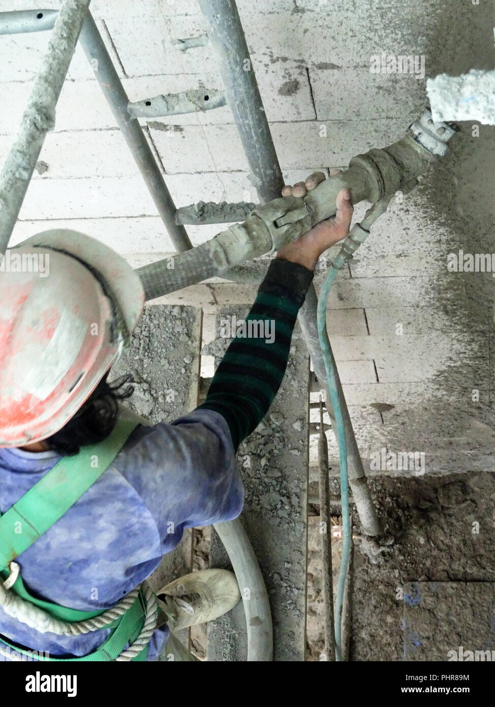 Construction workers plastering wall using cement plaster at the ...