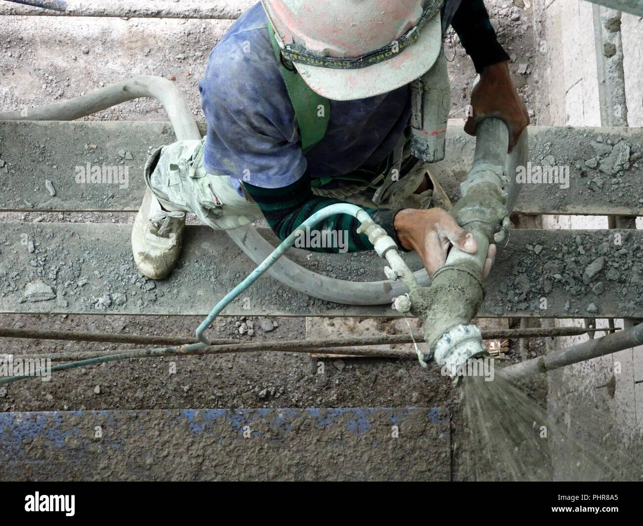 Construction workers plastering wall using cement plaster at the ...