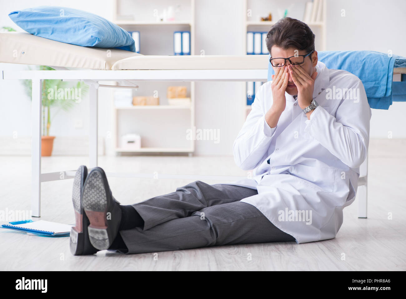 Doctor sitting on the floor in hospital Stock Photo - Alamy