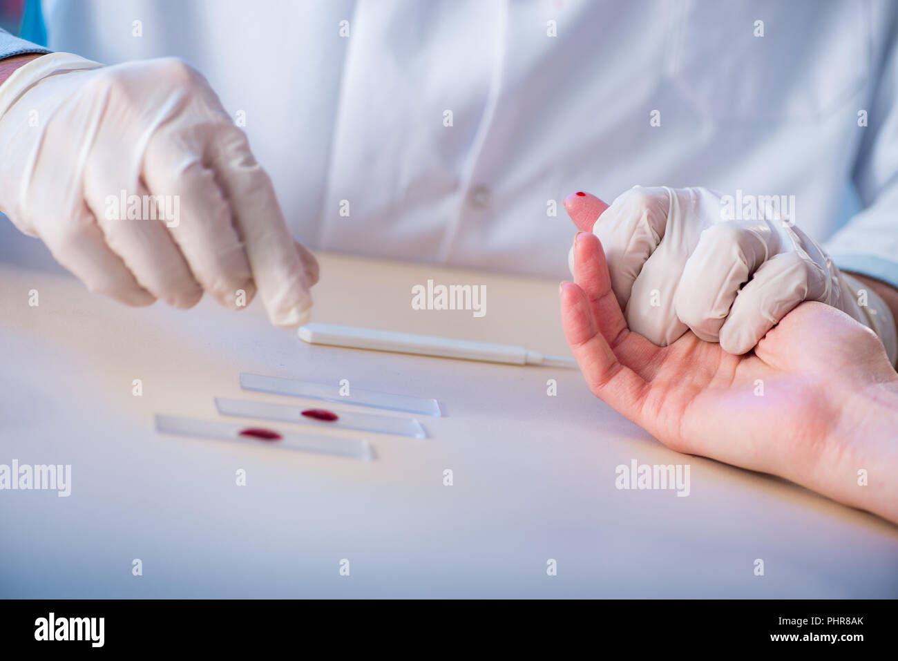 Doctor taking blood samples from finger Stock Photo - Alamy