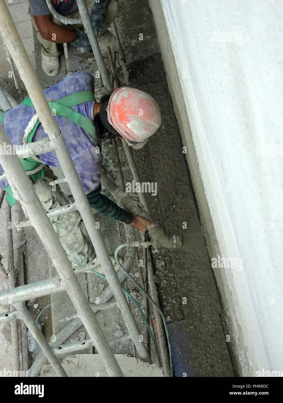 Construction workers plastering wall using cement plaster at the ...