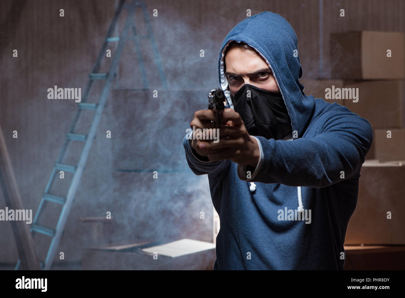 Aggressive manwith gun wearing face mask Stock Photo - Alamy