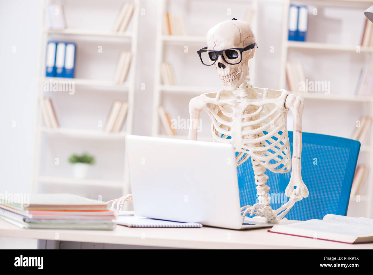 Skeleton businessman working in the office Stock Photo - Alamy