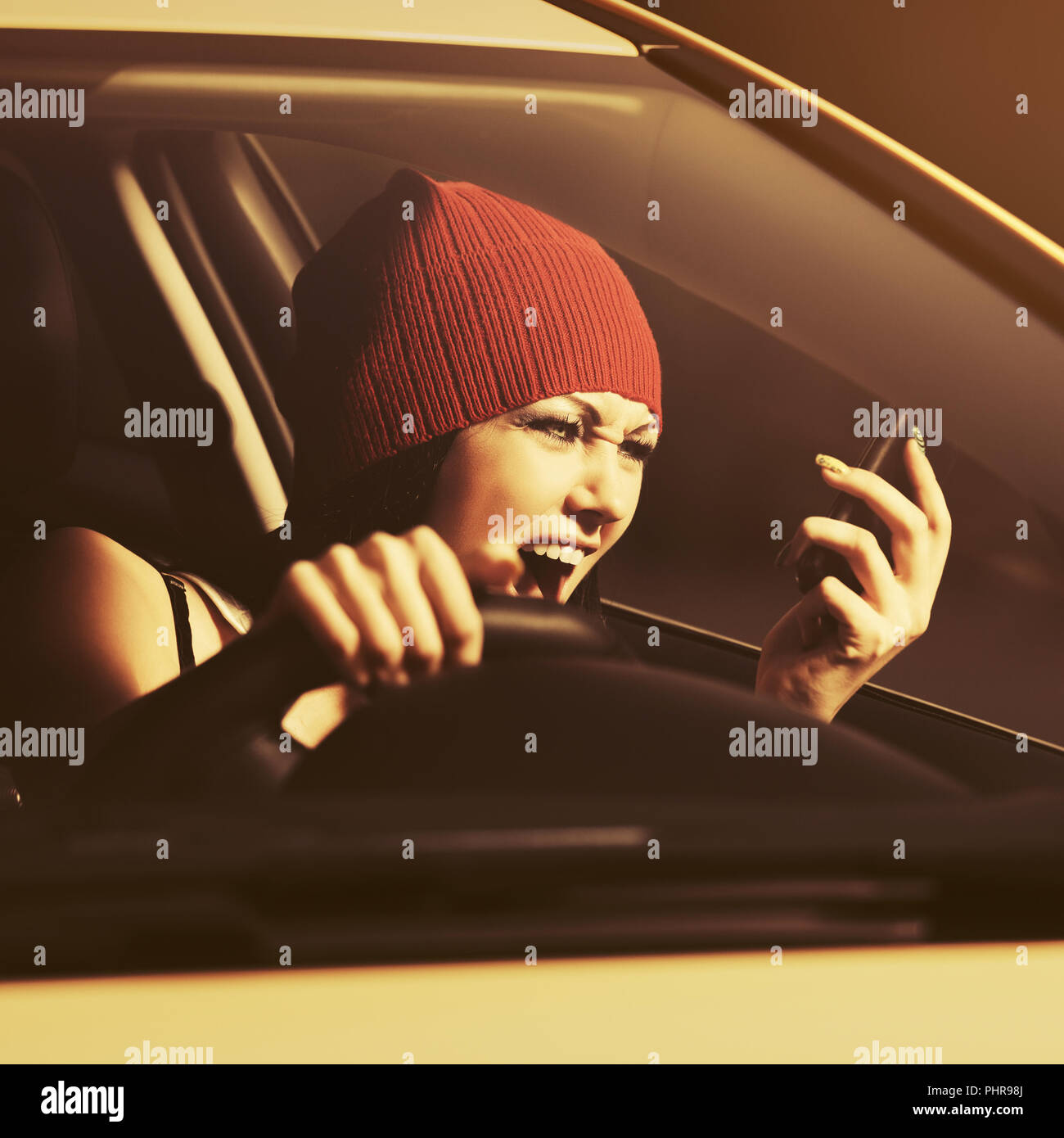 Angry woman shouting on cell phone driving a car Stock Photo - Alamy