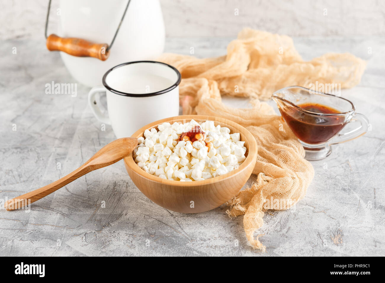 Granulated cottage cheese in wooden bowl and mug of milk Stock Photo ...