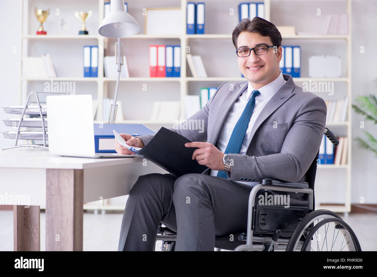 Disabled businessman working in the office Stock Photo - Alamy