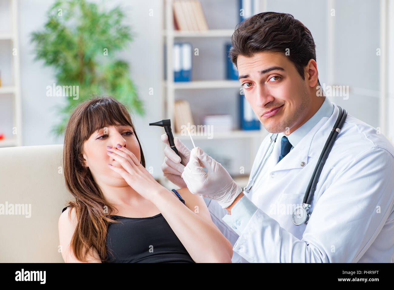 Doctor checking patients ear during medical examination Stock Photo - Alamy
