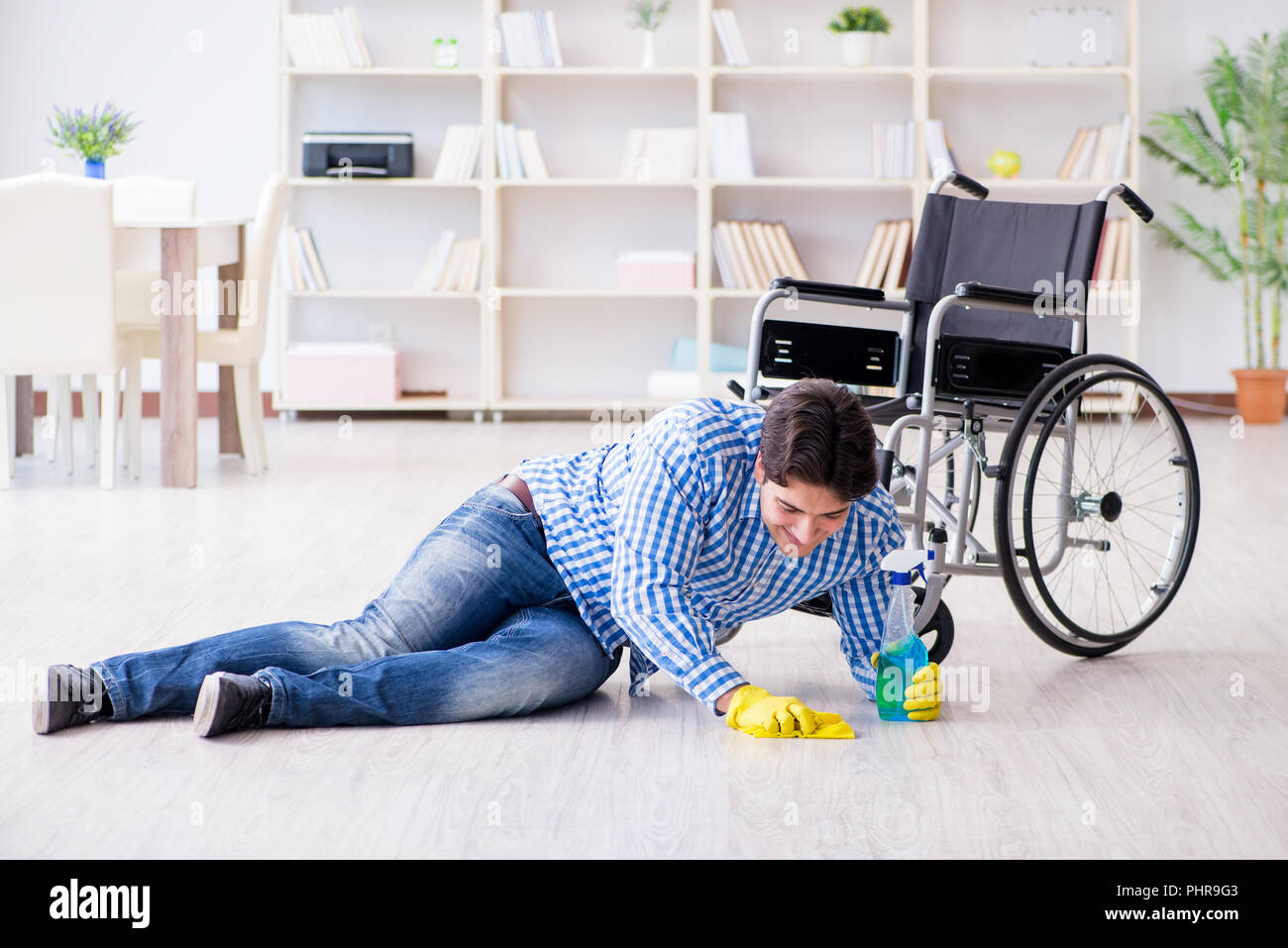 Disabled man on wheelchair cleaning home Stock Photo - Alamy