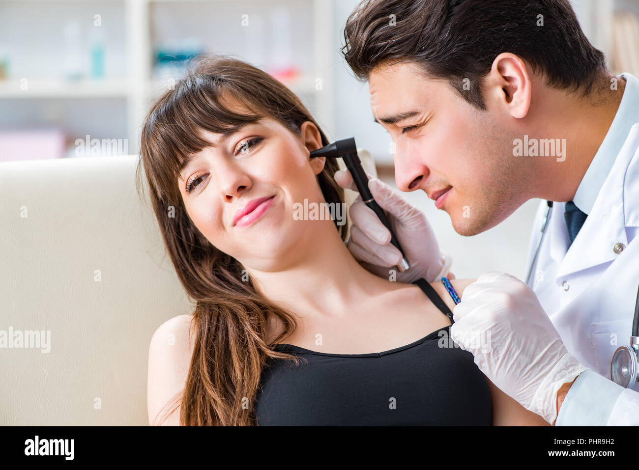 Doctor checking patients ear during medical examination Stock Photo - Alamy