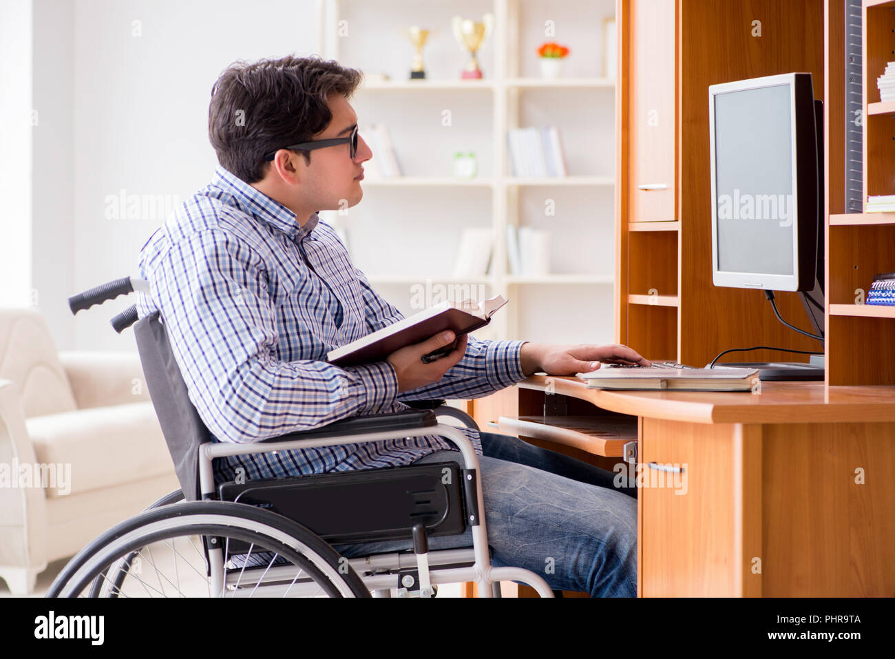 Disabled student studying at home on wheelchair Stock Photo - Alamy