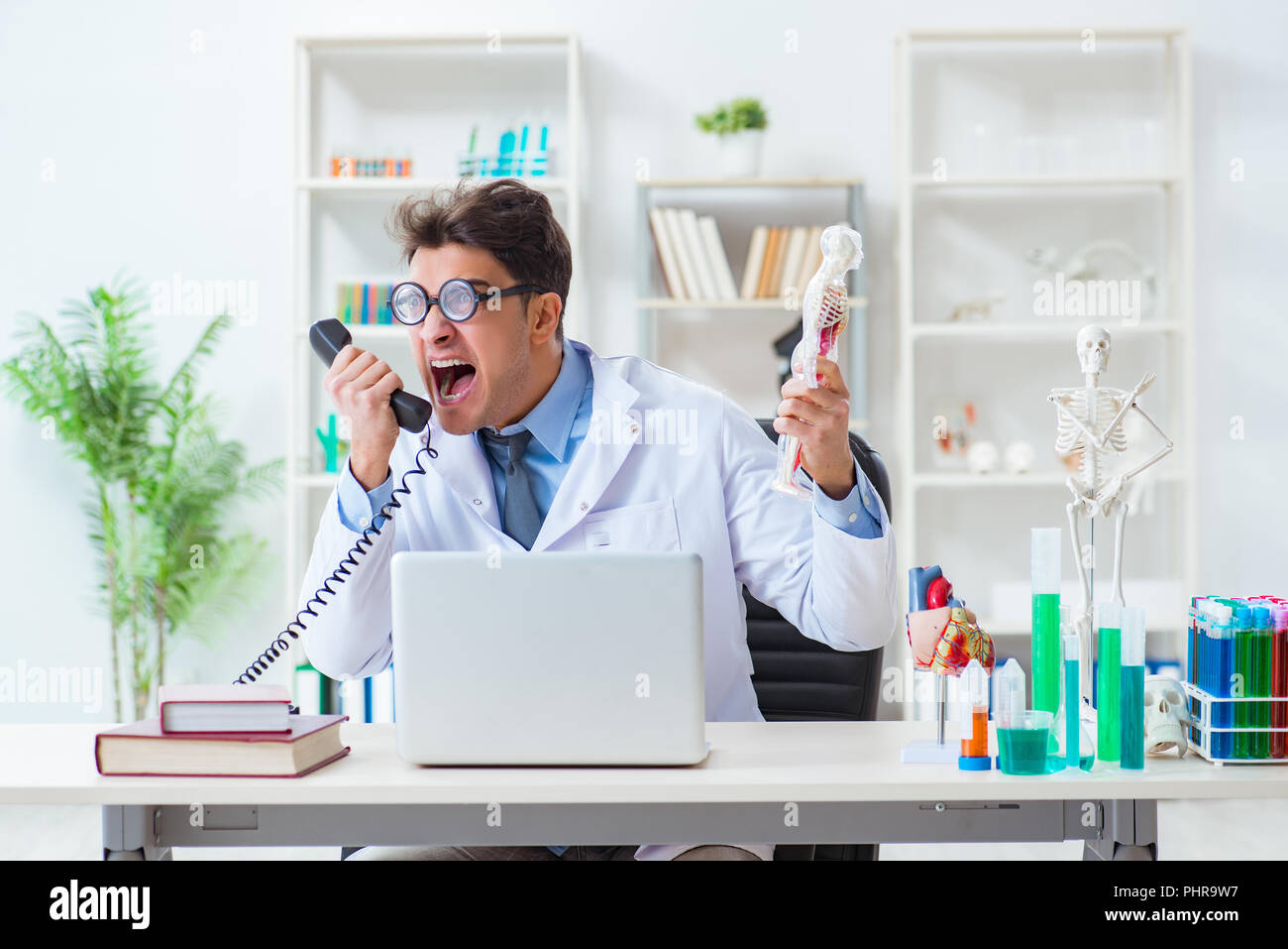 Funny doctor having fun in hospital lab Stock Photo - Alamy
