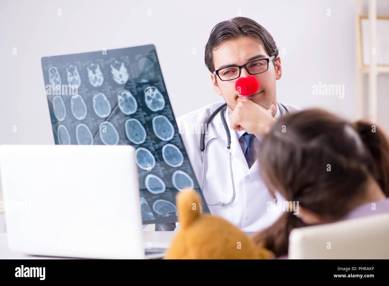Funny pediatrician with little girl at regular check-up Stock Photo - Alamy