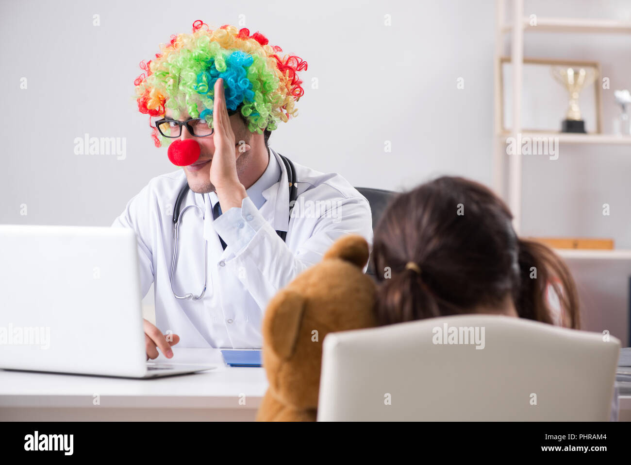 Funny pediatrician with little girl at regular check-up Stock Photo - Alamy