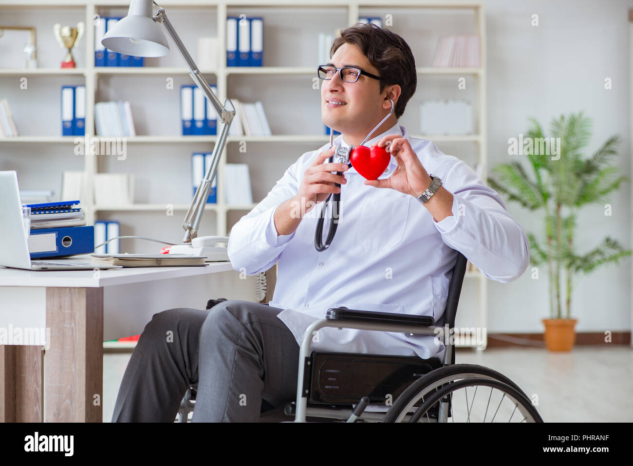 Disabled doctor on wheelchair working in hospital Stock Photo - Alamy