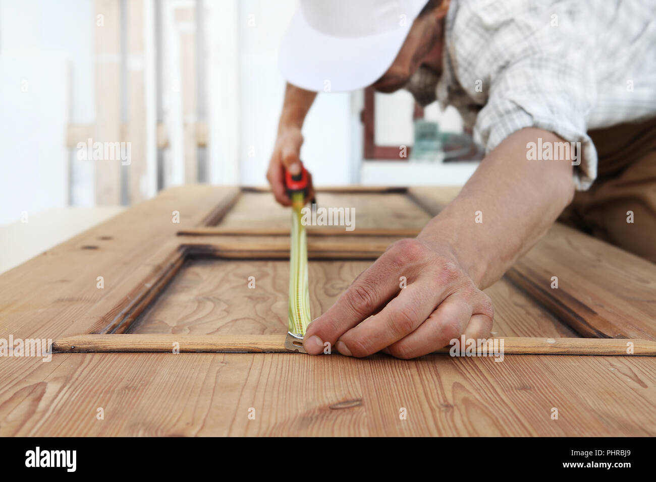 carpenter work the wood, measuring with meter tape a wooden vintage ...