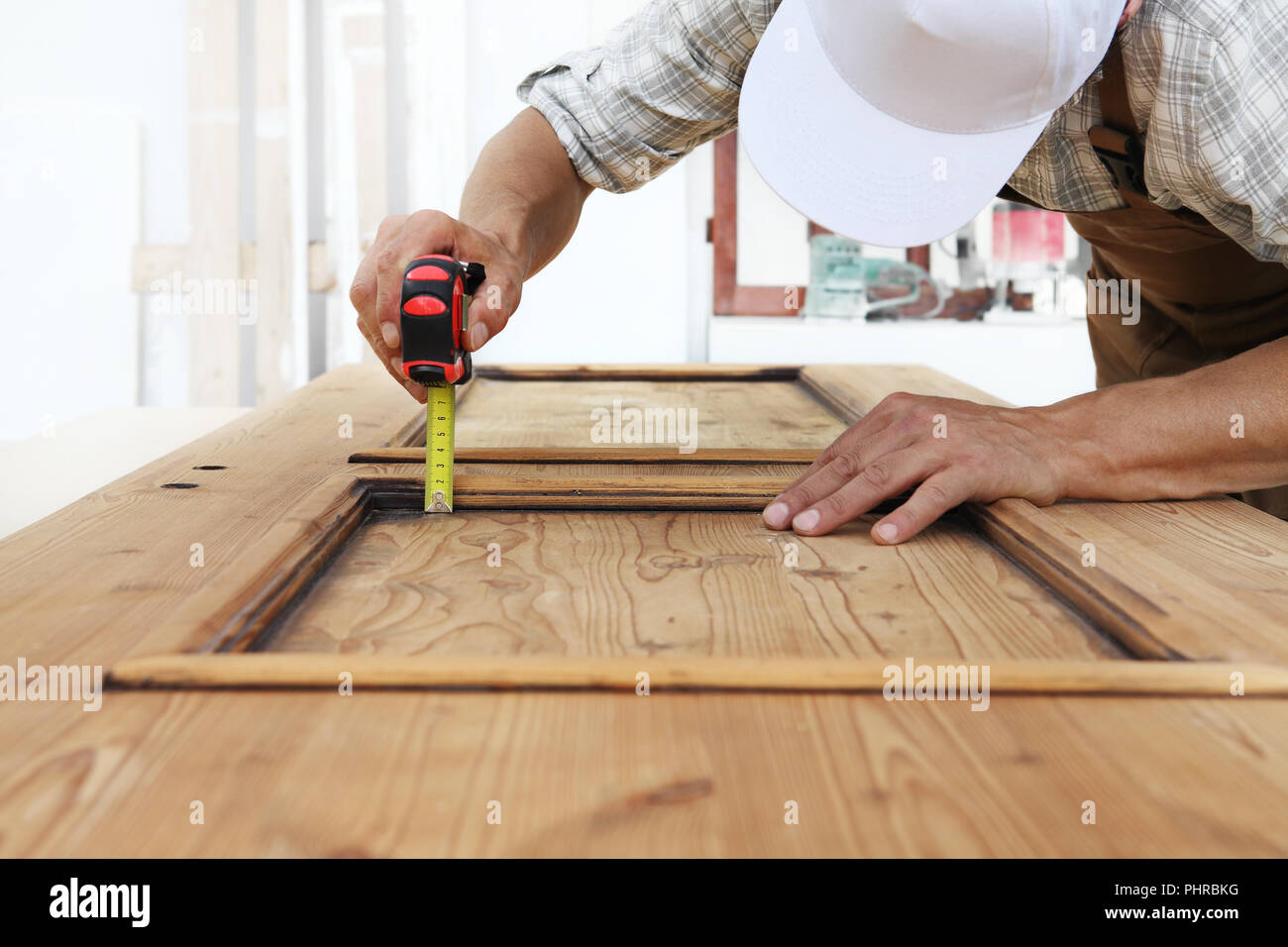 carpenter work the wood, measuring with meter tape a wooden vintage ...