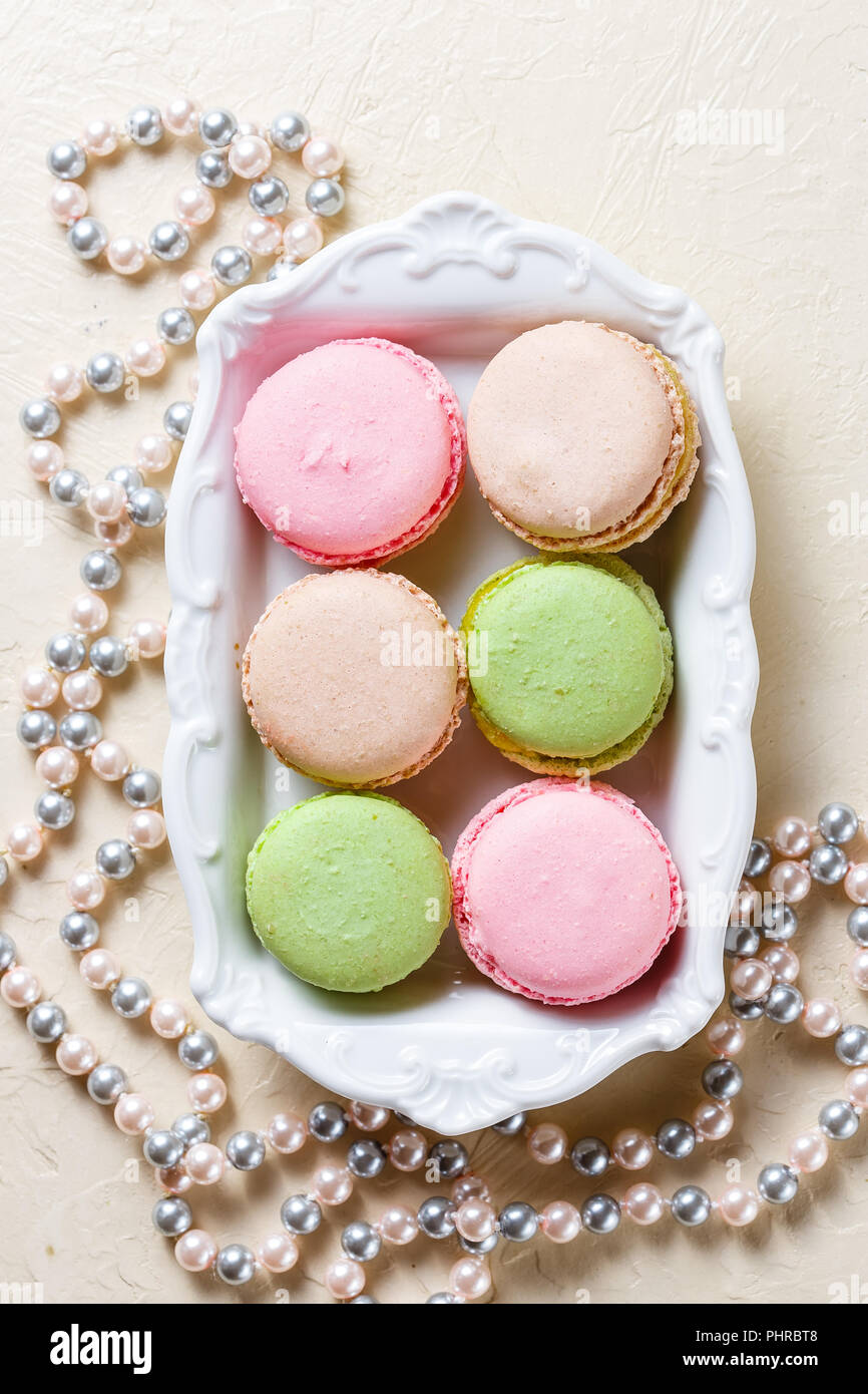Colourful macaroons on the plates Stock Photo - Alamy