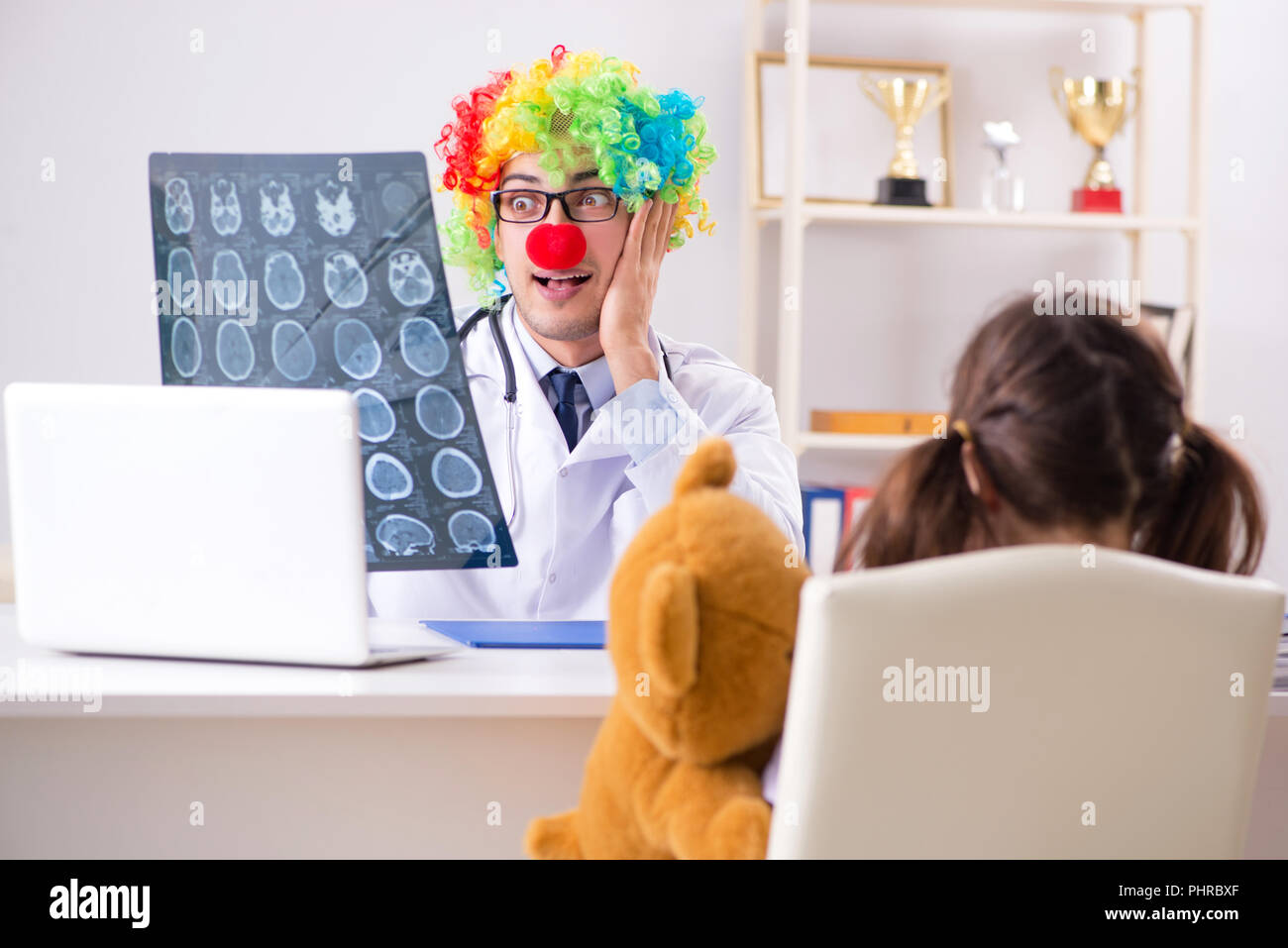 Funny pediatrician with little girl at regular check-up Stock Photo - Alamy