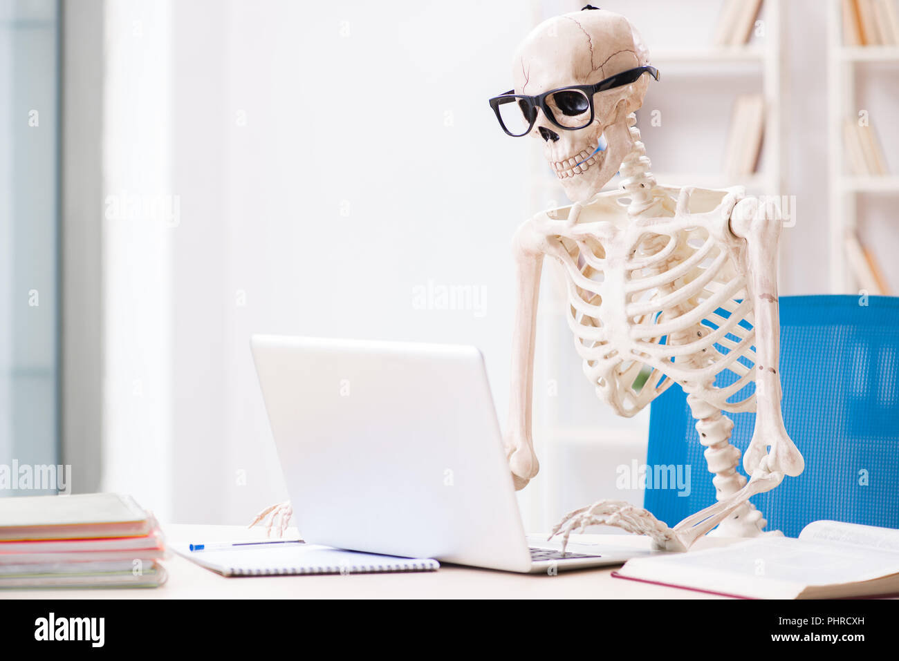 Skeleton businessman working in the office Stock Photo - Alamy