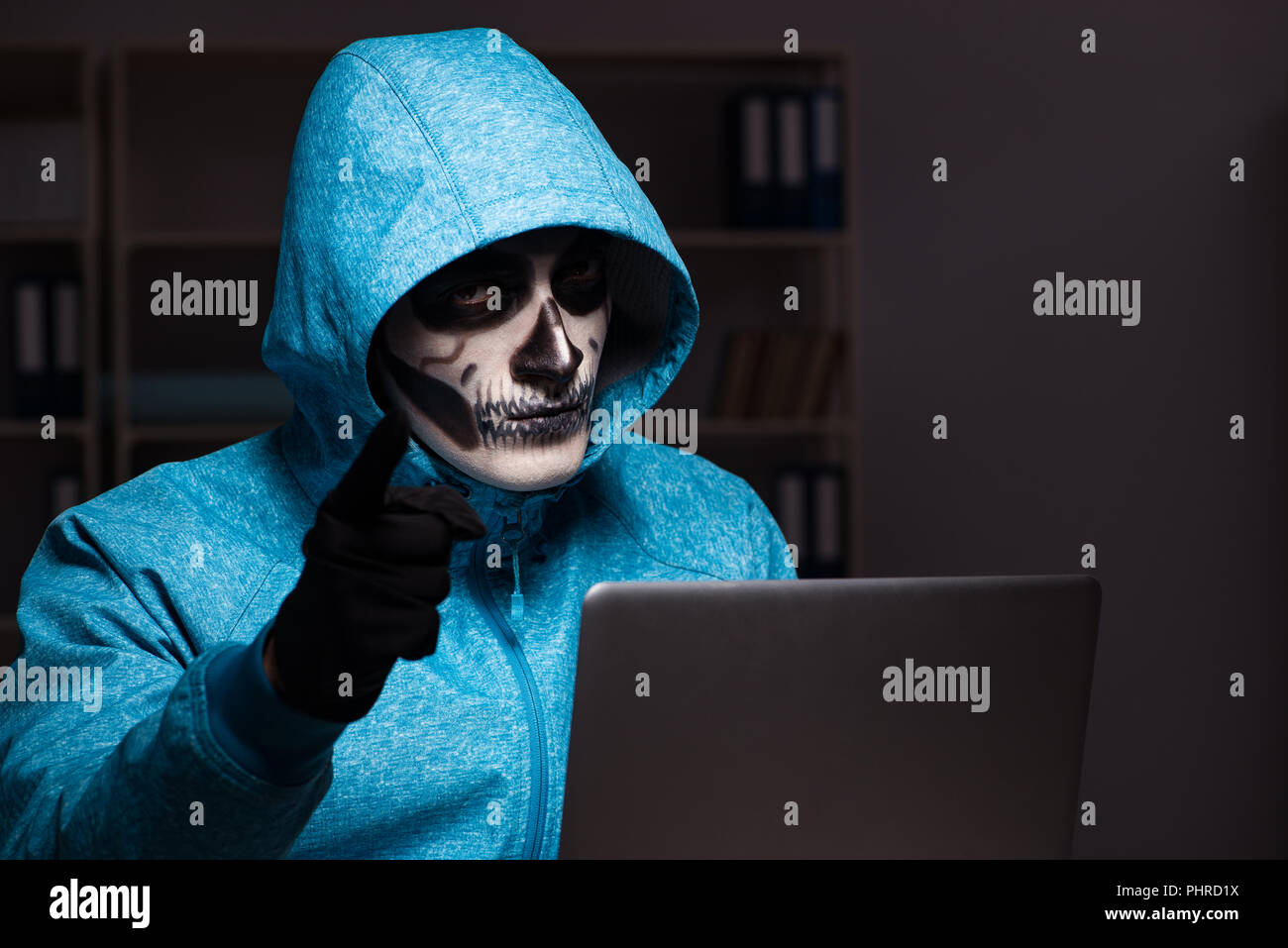 Scary hacker hacking security firewall late in office Stock Photo - Alamy