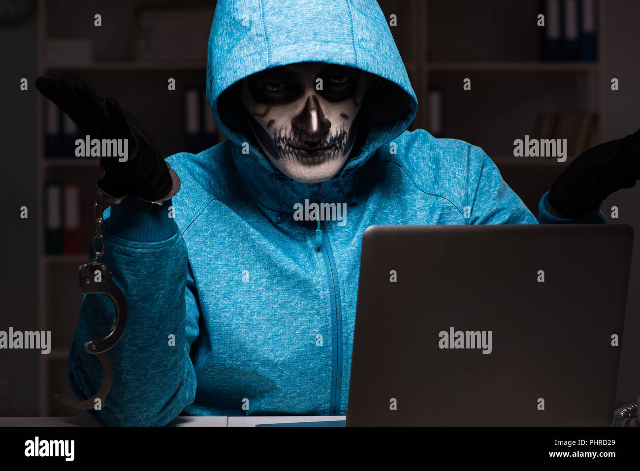 Scary hacker hacking security firewall late in office Stock Photo - Alamy